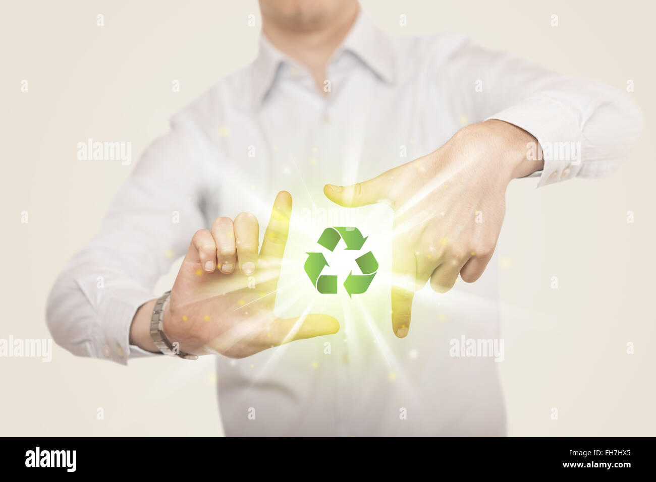 Hands creating a form with recycling sign Stock Photo - Alamy