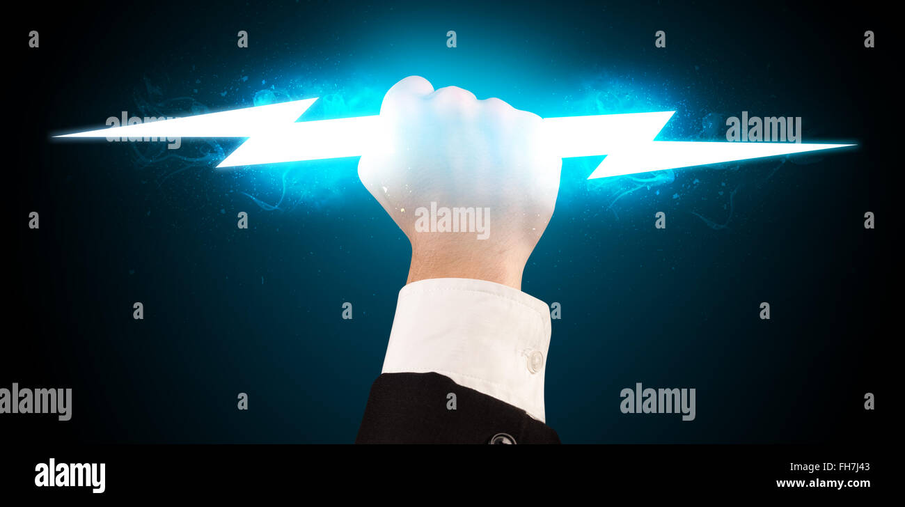 Business man holding glowing lightning bolt in his hands Stock Photo ...