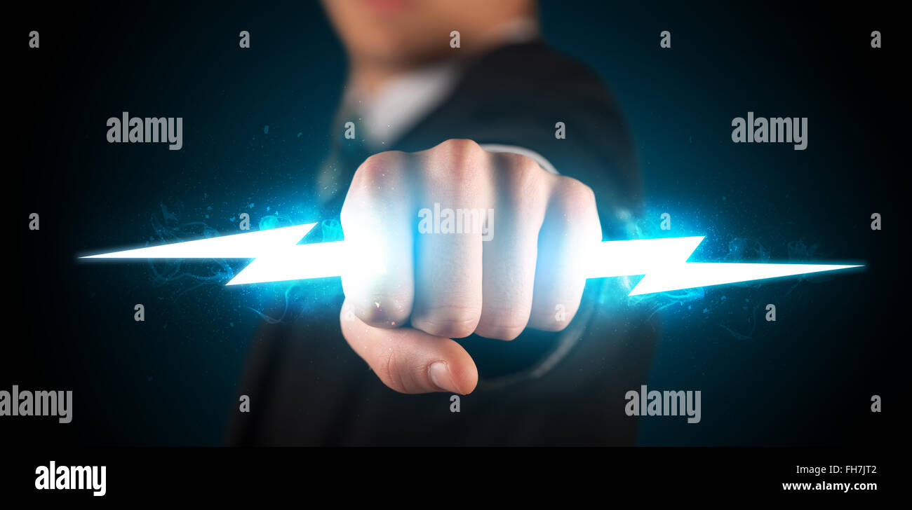Business man holding glowing lightning bolt in his hands Stock Photo ...