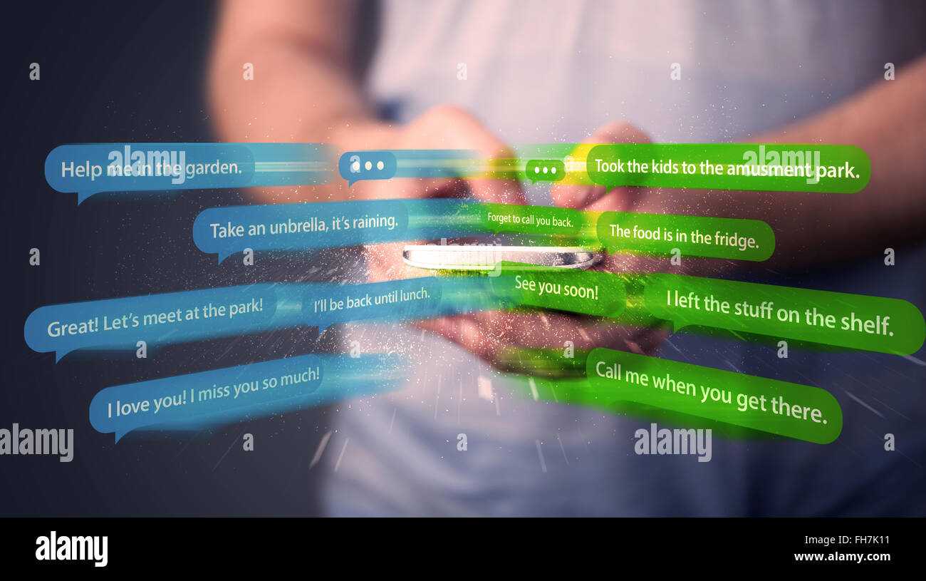 Young man writing messages with smartphone Stock Photo - Alamy