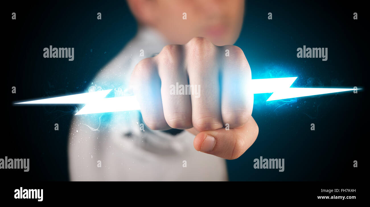 Business man holding glowing lightning bolt in his hands Stock Photo ...