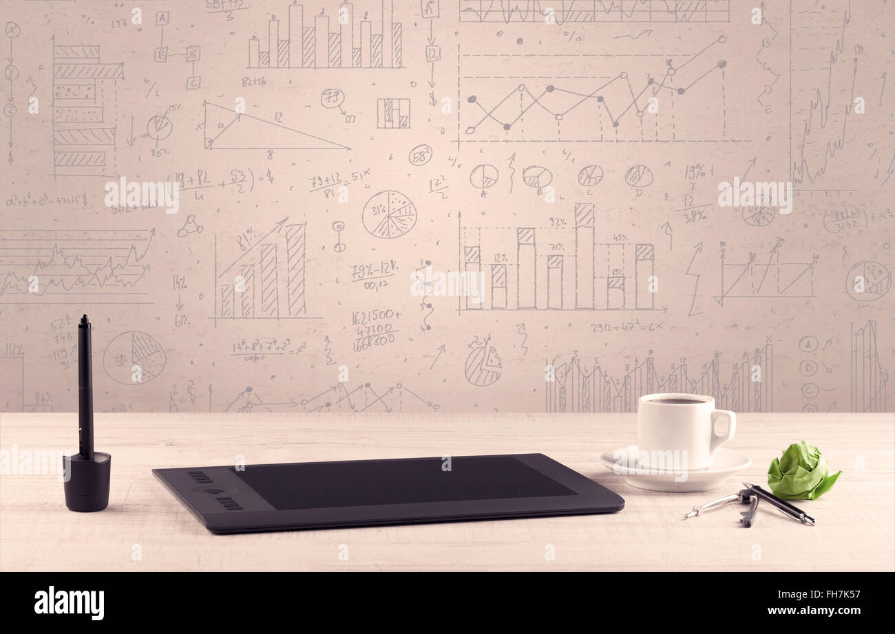 Graph charts and designer office desk Stock Photo - Alamy