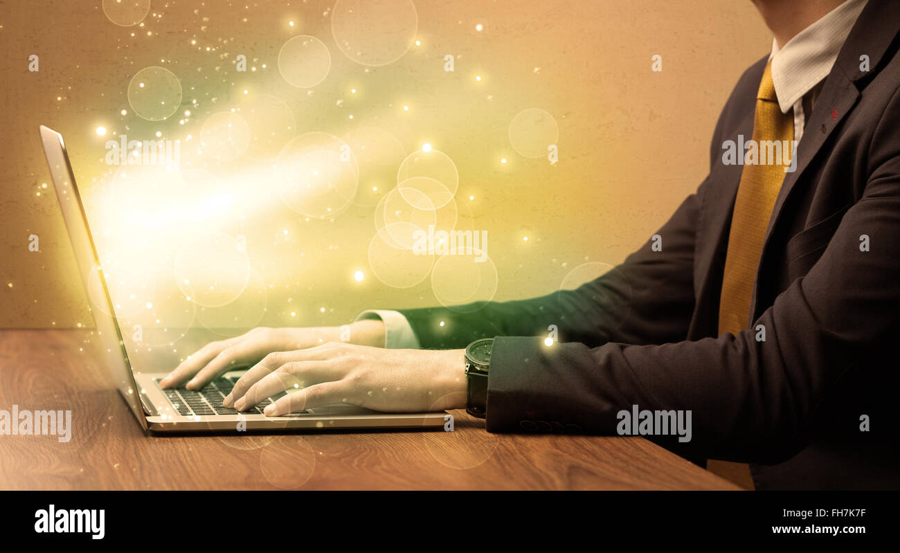 Businessman working fast on laptop Stock Photo - Alamy
