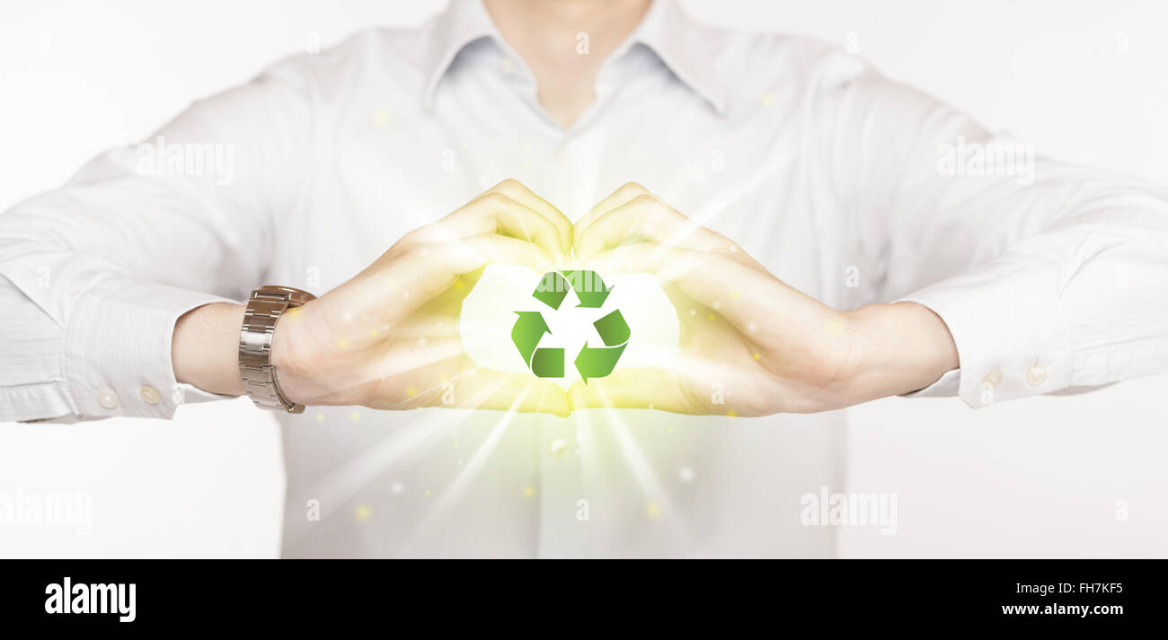 Hands creating a form with recycling sign Stock Photo - Alamy