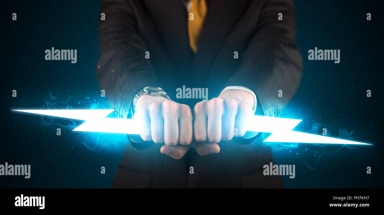 Business man holding glowing lightning bolt in his hands Stock Photo ...