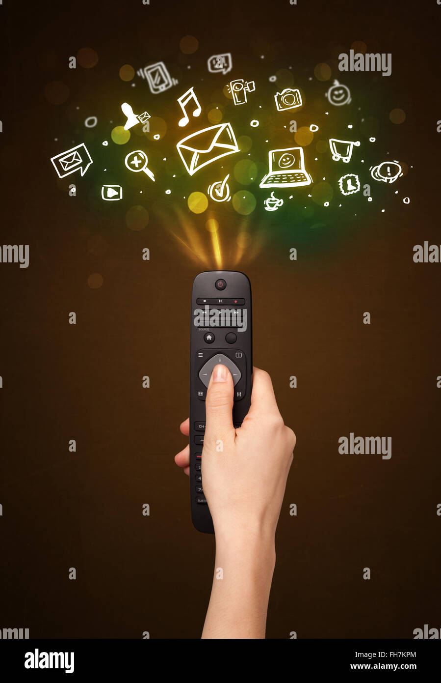 Hand with remote control and social media icons Stock Photo - Alamy