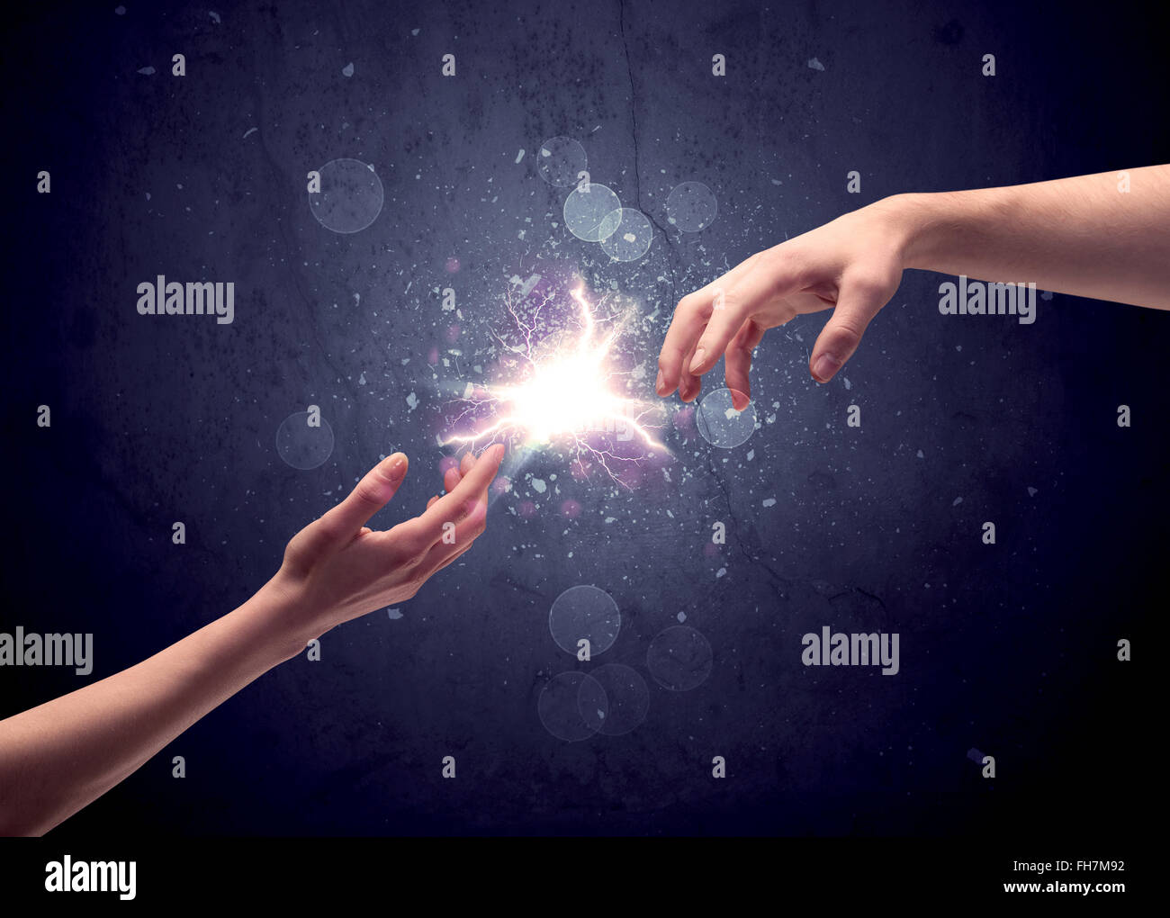 Hands reaching to light a spark Stock Photo - Alamy