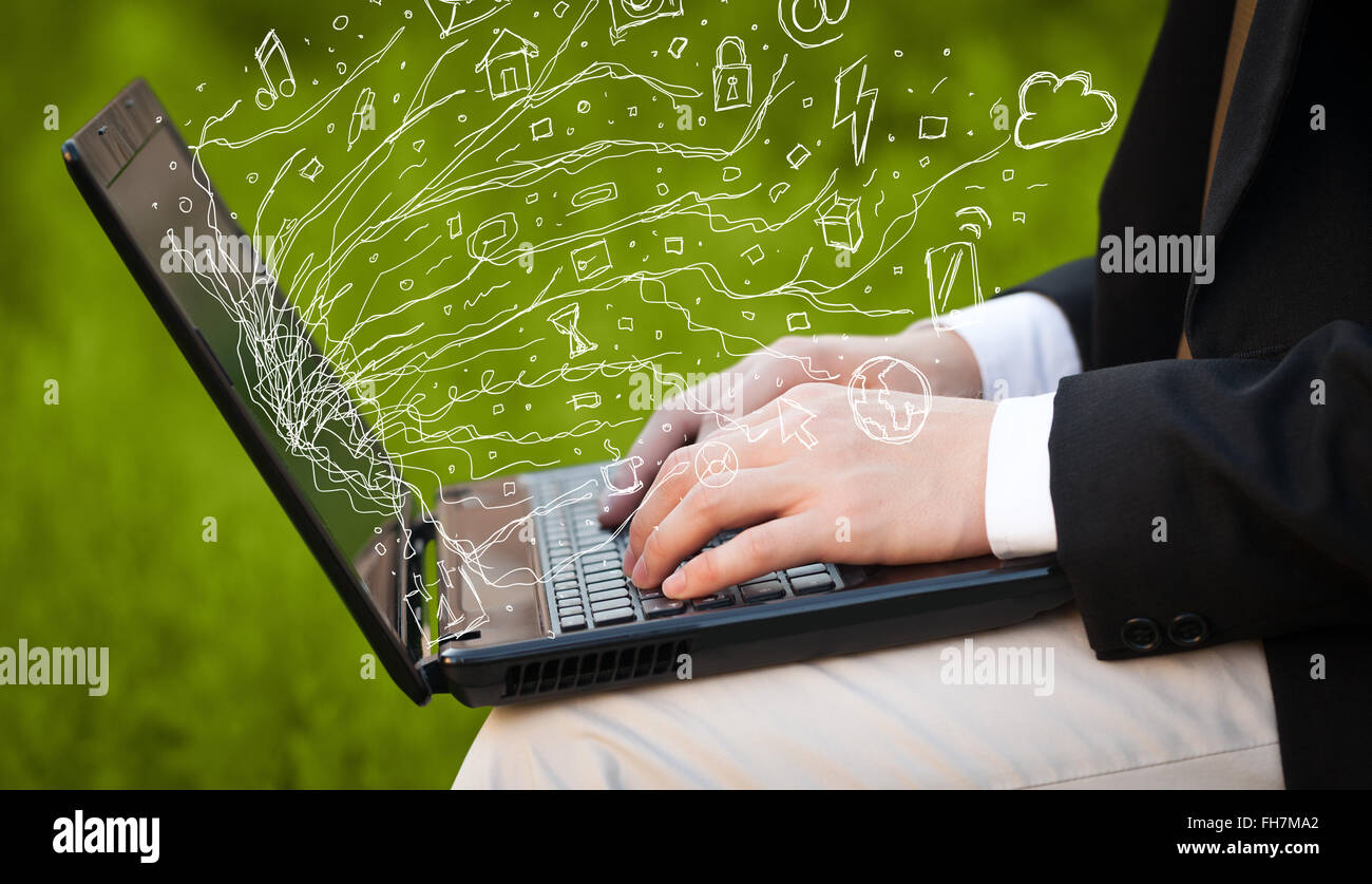 Man pressing notebook laptop computer with doodle icon cloud symbols ...