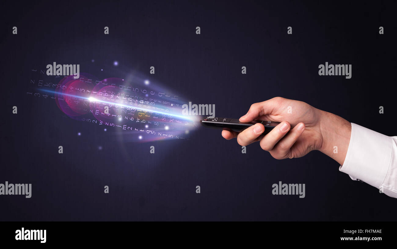 Hand with remote control and shining numbers Stock Photo - Alamy
