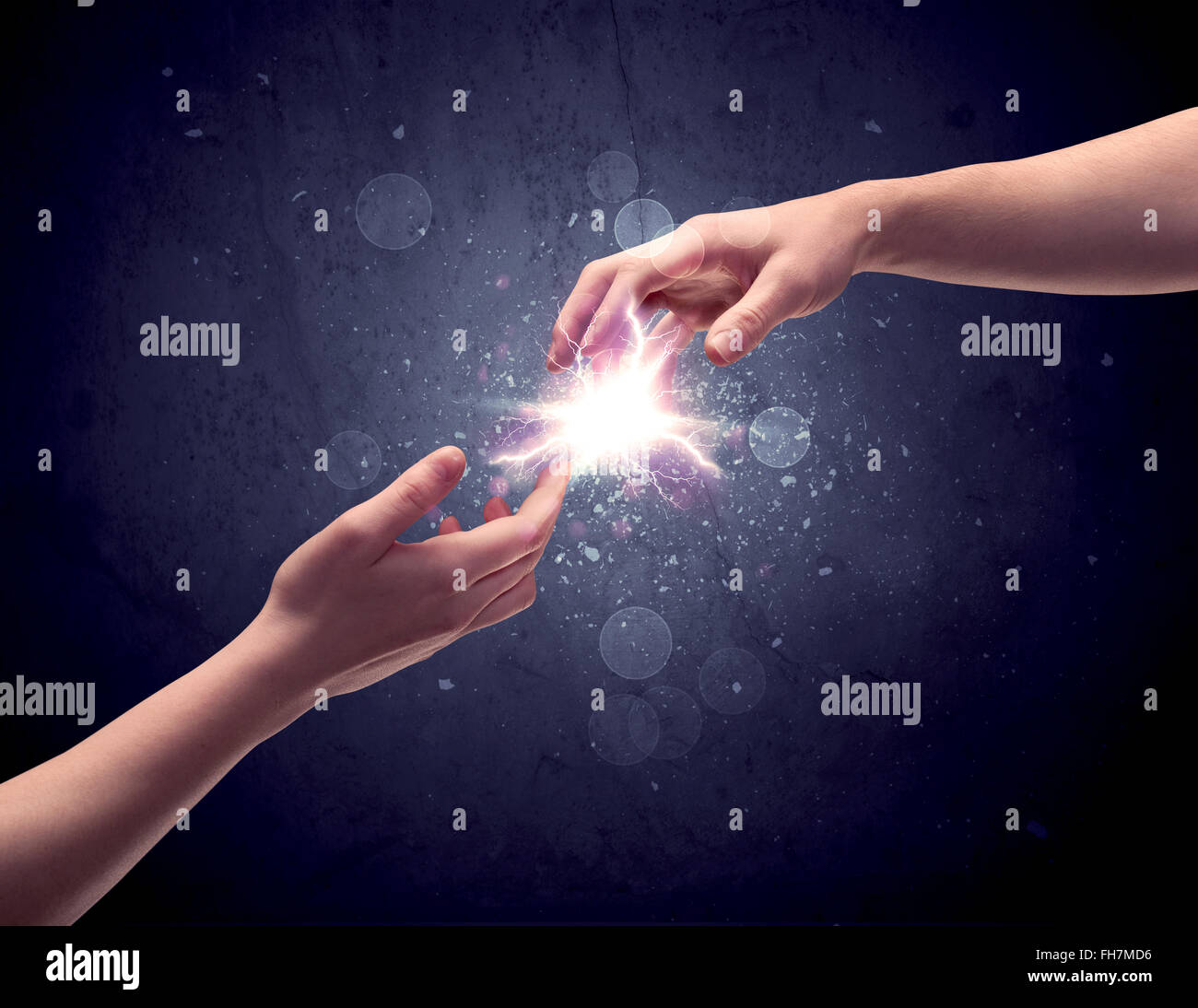 Hands reaching to light a spark Stock Photo - Alamy
