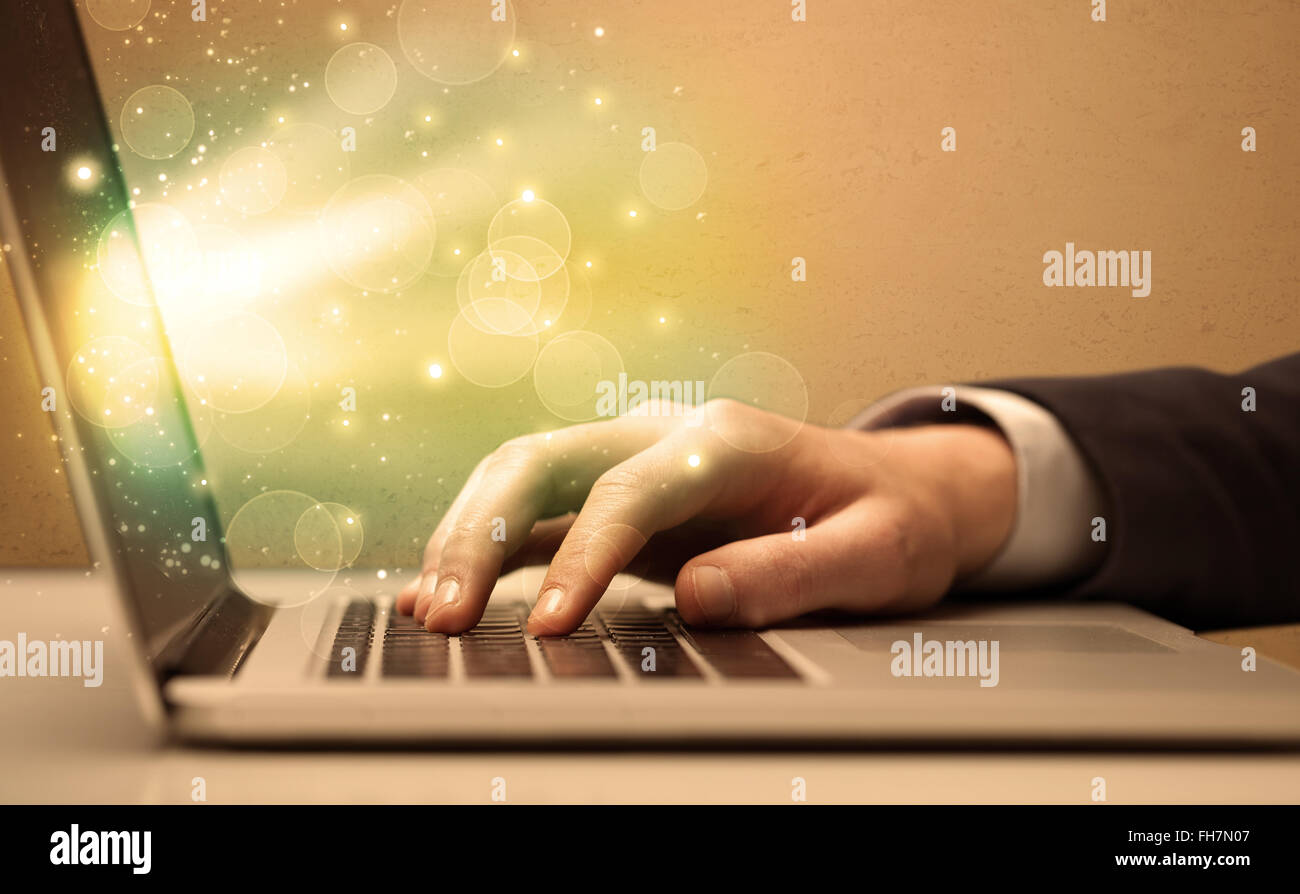 Businessman working fast on laptop Stock Photo - Alamy