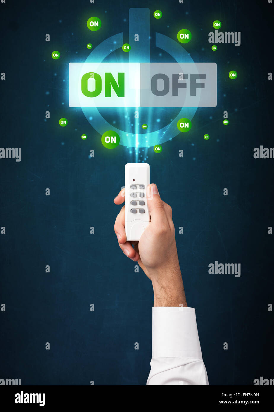 Hand with remote control and on-off signals Stock Photo - Alamy