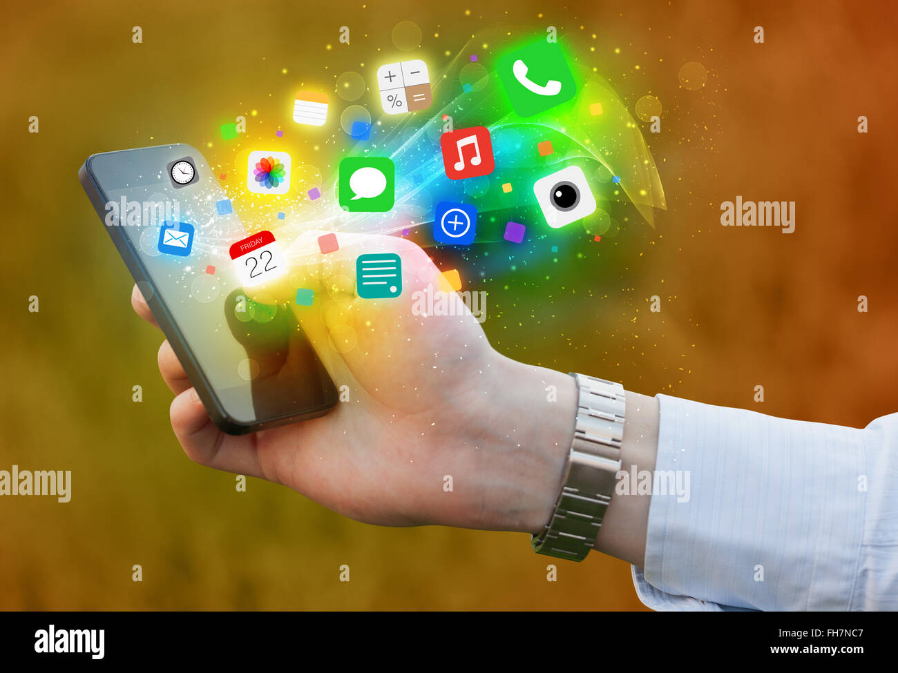 Hand holding smartphone with colorful app icons Stock Photo - Alamy