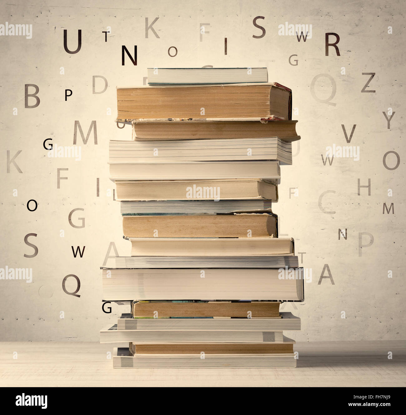Books with flying letters on vintage background Stock Photo - Alamy