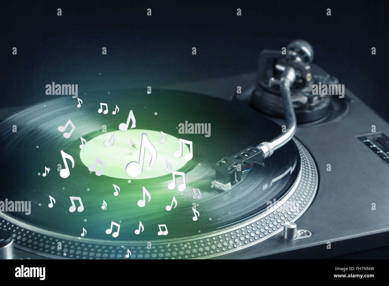 Turntable playing music with audio notes glowing Stock Photo - Alamy