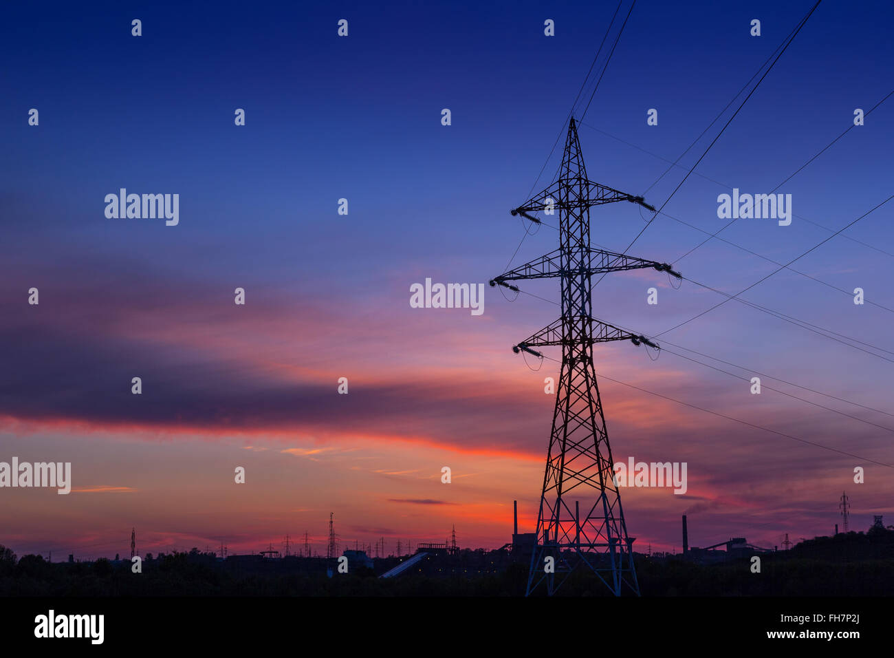Electric pylons at sunset Stock Photo - Alamy