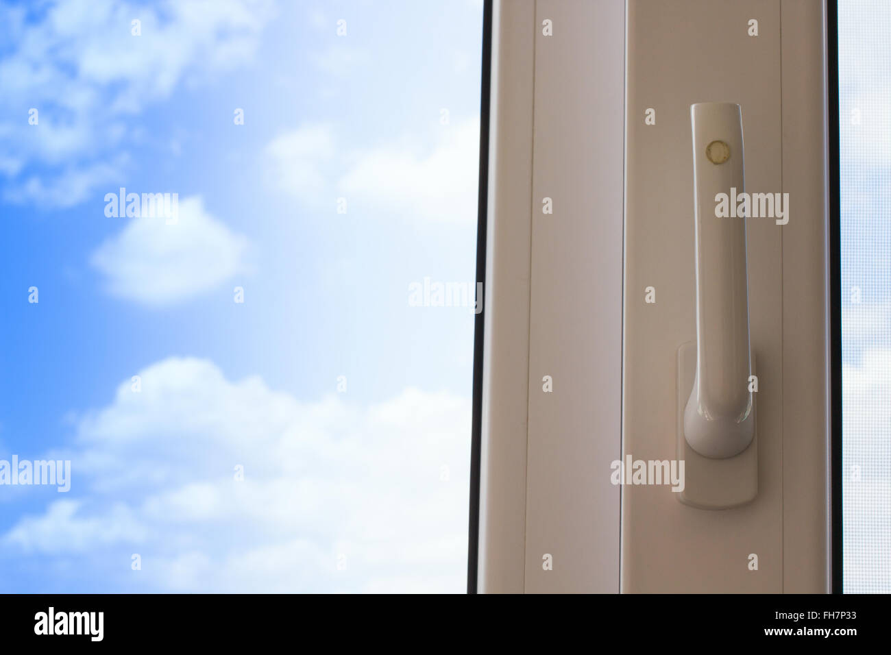 Folded open window with blue sky in background Stock Photo - Alamy