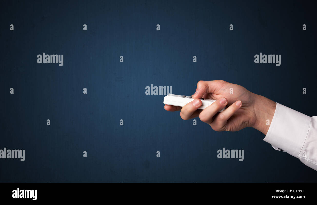 Hand with remote control Stock Photo - Alamy