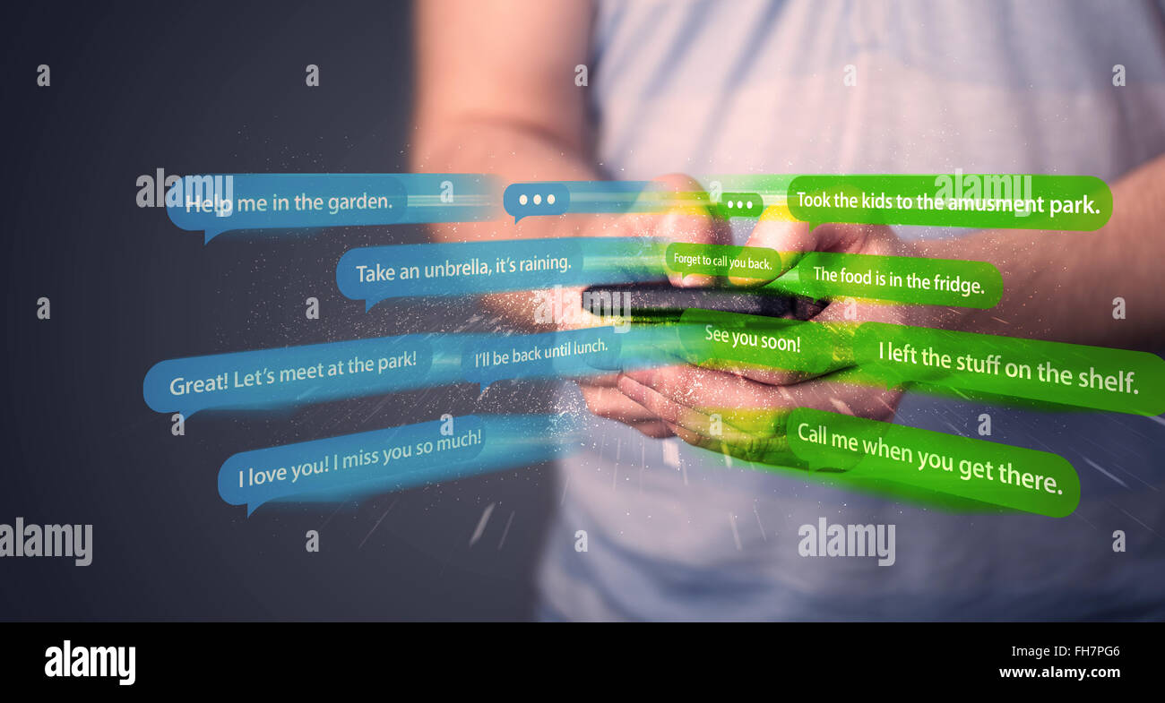 Young man writing messages with smartphone Stock Photo - Alamy