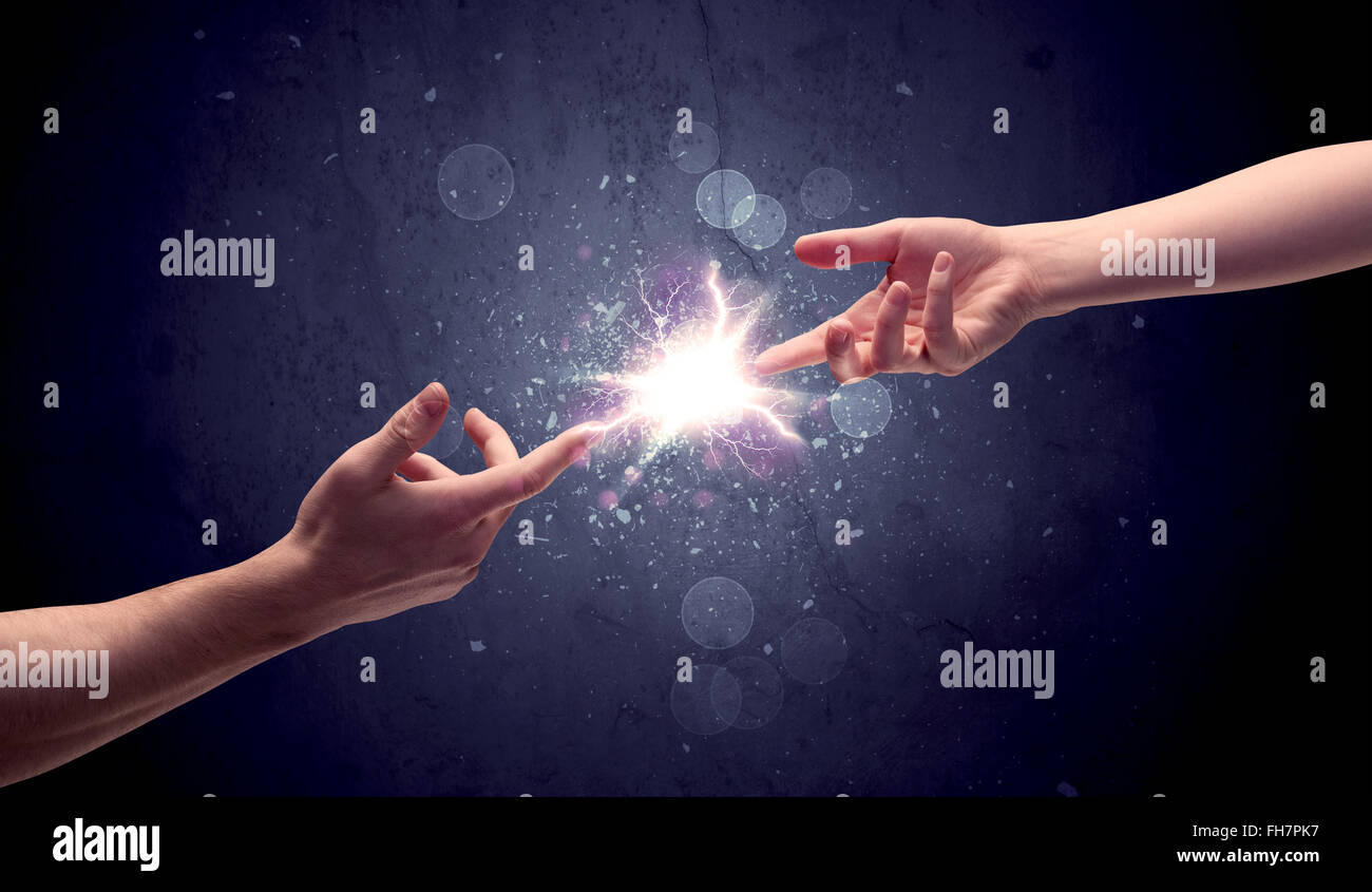 Hands reaching to light a spark Stock Photo - Alamy