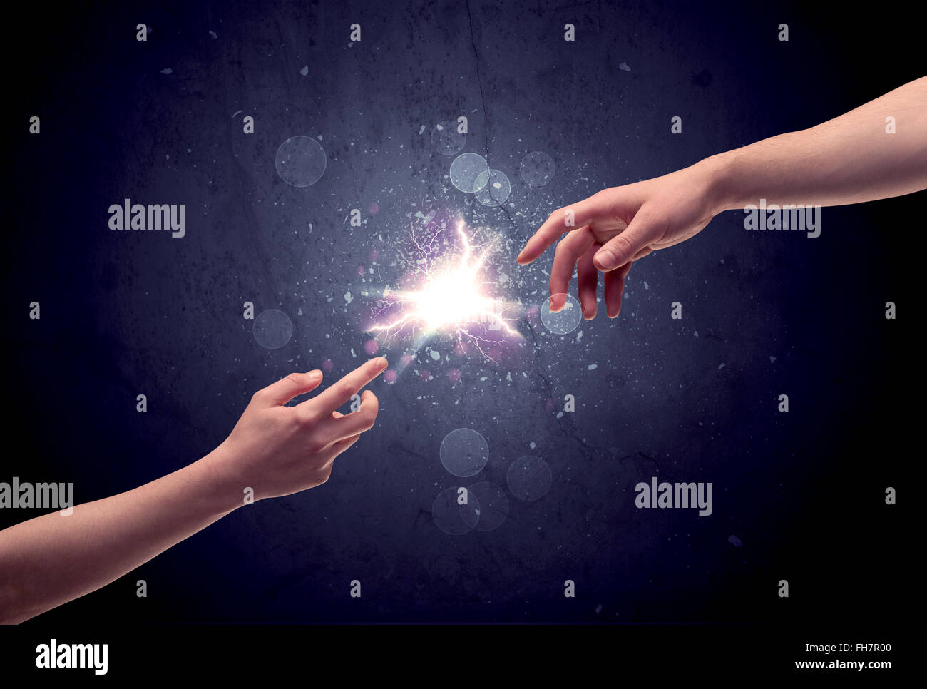 Hands reaching to light a spark Stock Photo - Alamy