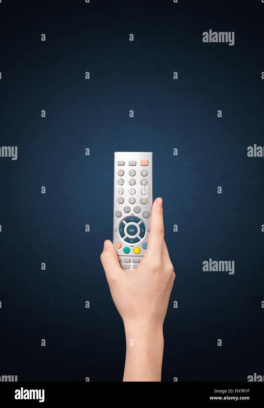 Hand with remote control Stock Photo - Alamy