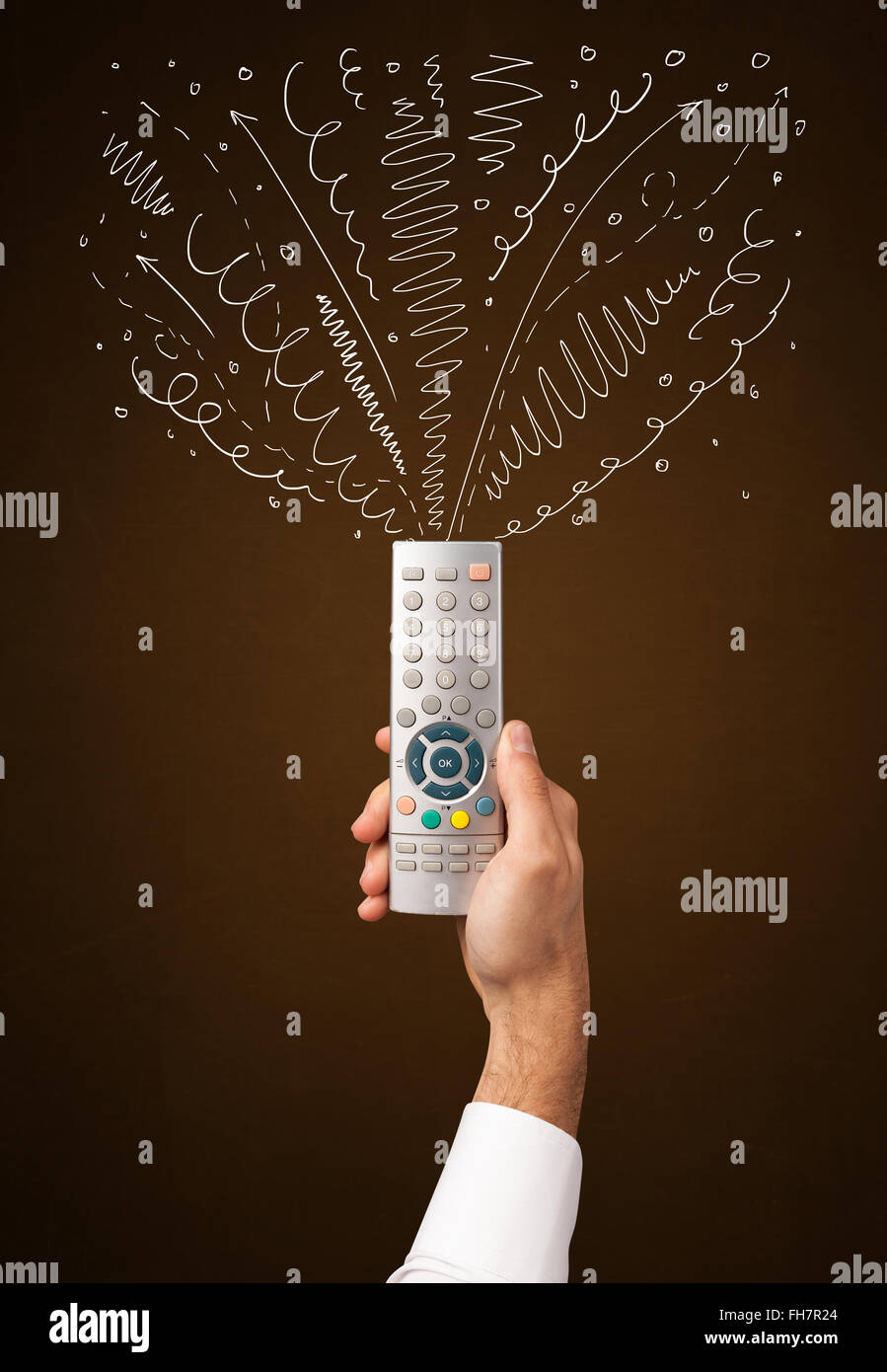 Hand with remote control and curly lines Stock Photo - Alamy