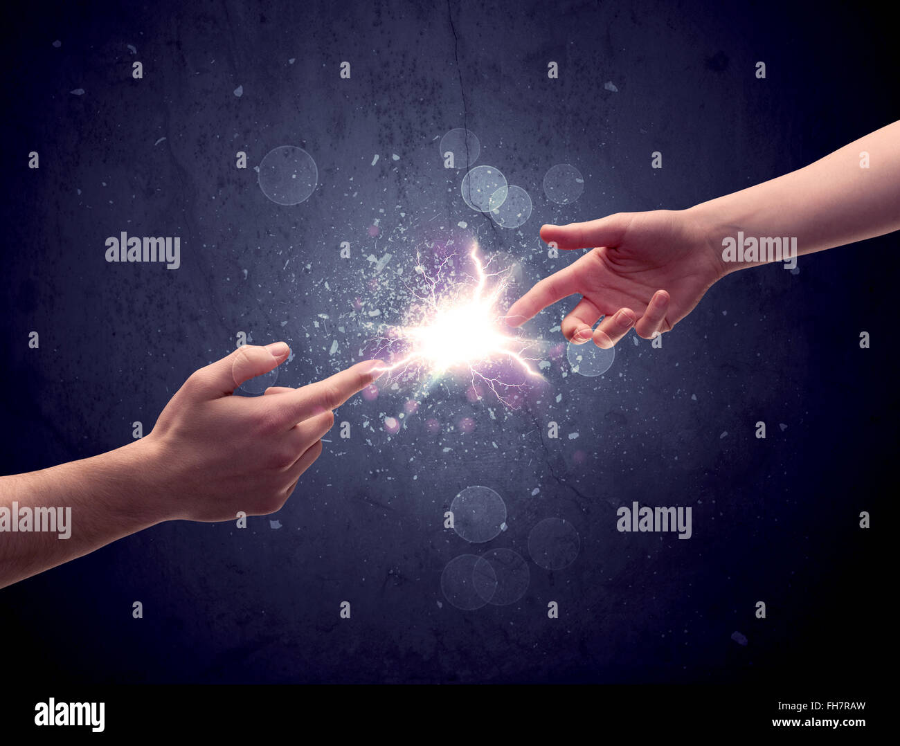 Hands reaching to light a spark Stock Photo - Alamy