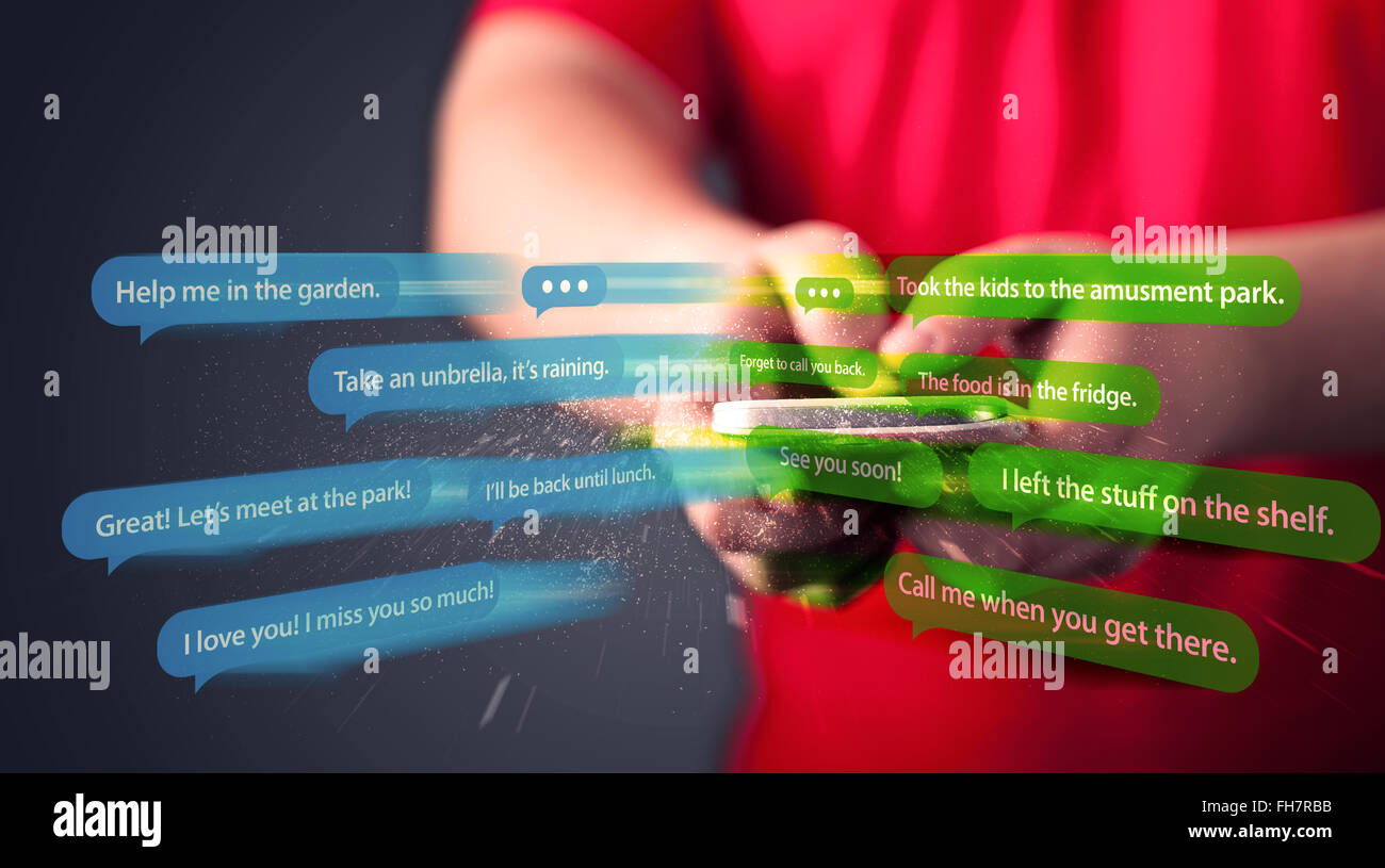 Young man writing messages with smartphone Stock Photo - Alamy