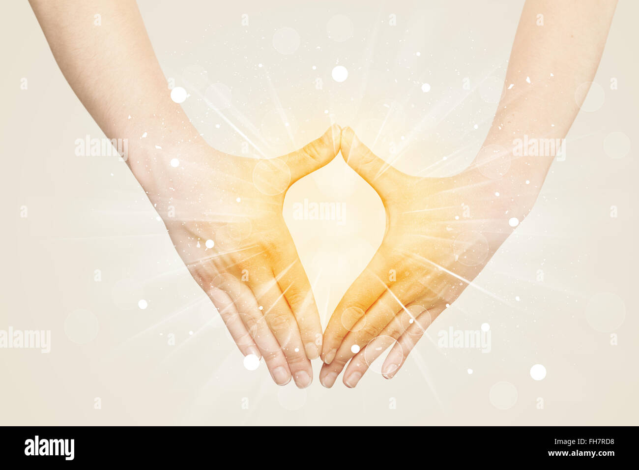 Hands creating a form with yellow shines Stock Photo - Alamy