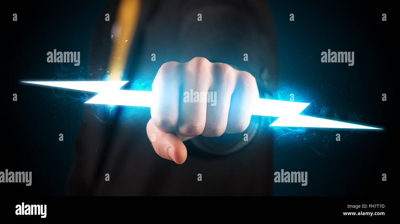 Business man holding glowing lightning bolt in his hands Stock Photo ...