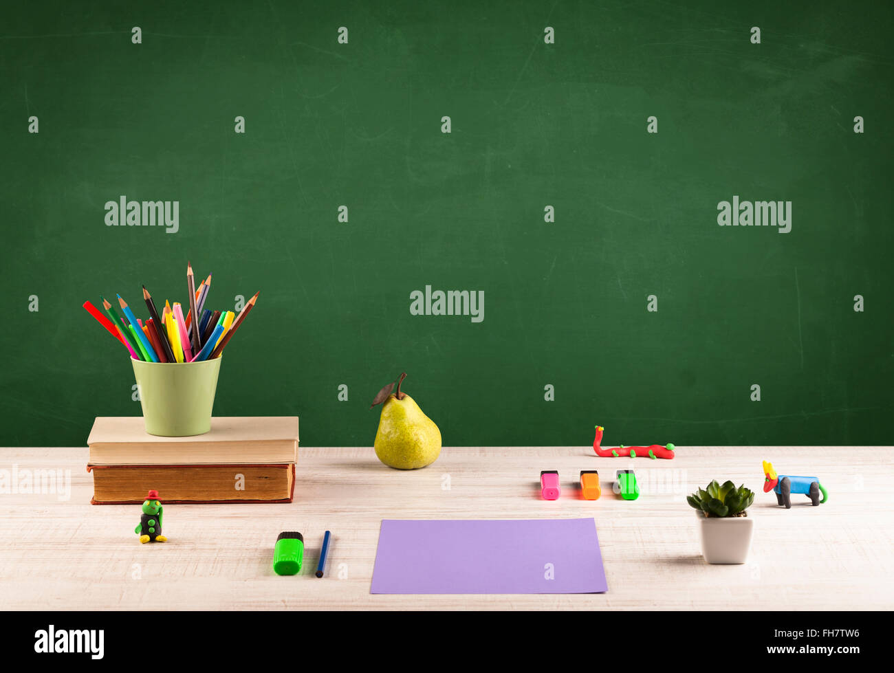 School items on desk with empty chalkboard Stock Photo - Alamy