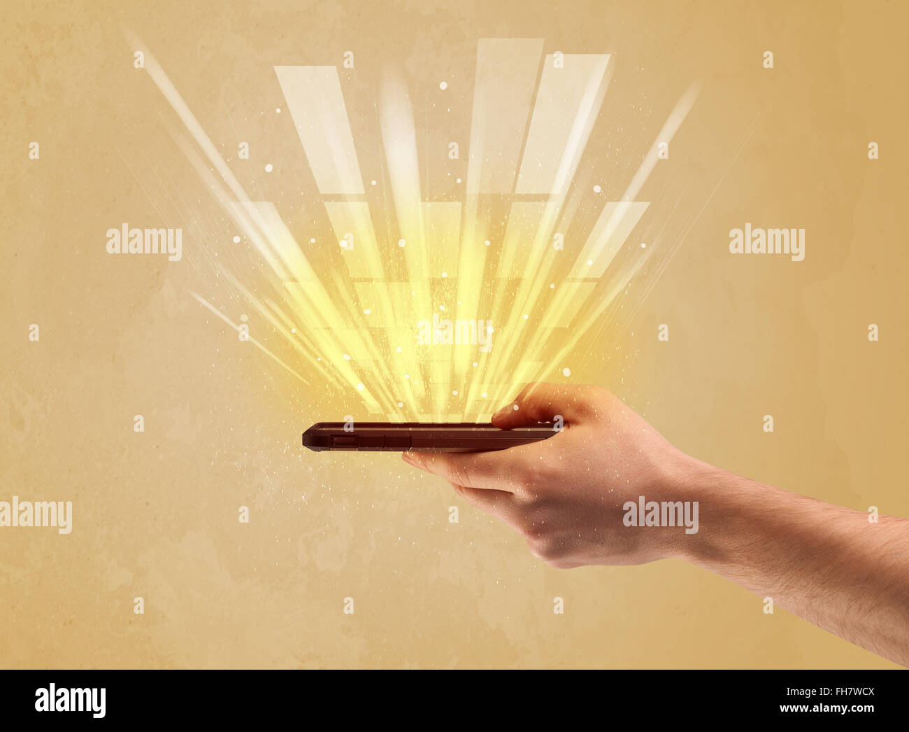 Hand with telephone and yellow light Stock Photo - Alamy