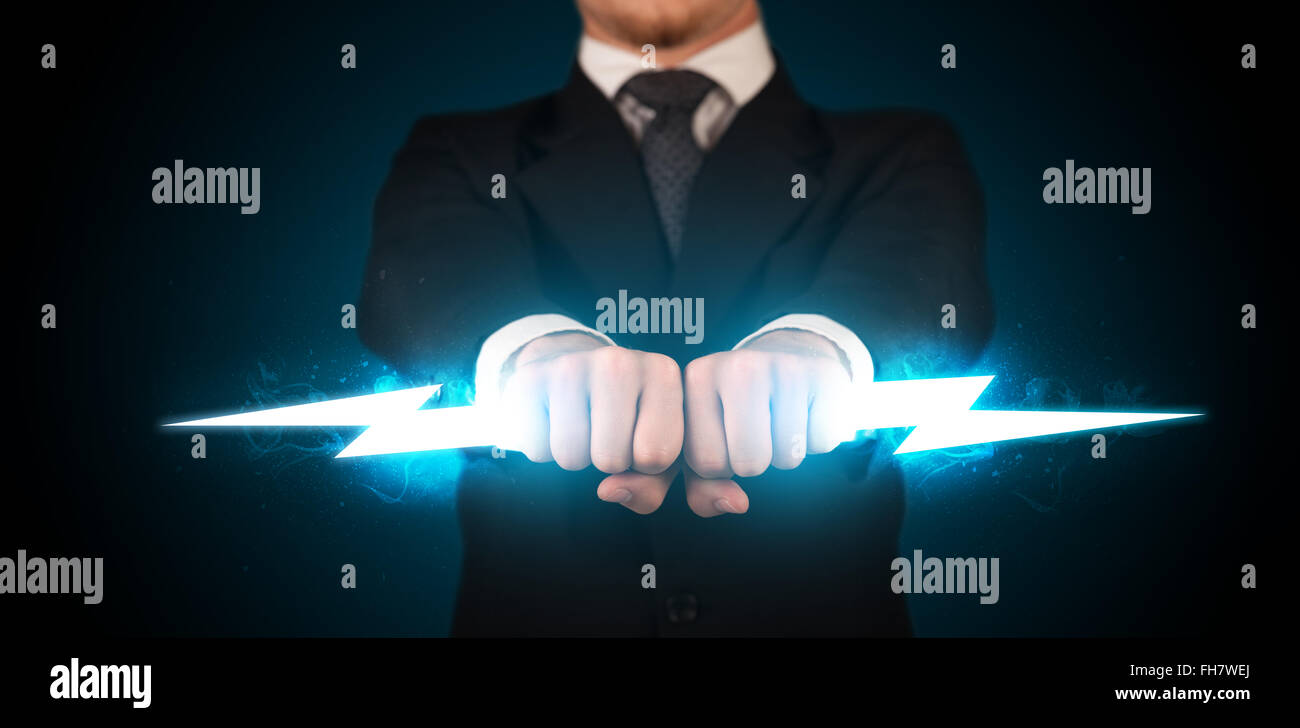 Business man holding glowing lightning bolt in his hands Stock Photo ...
