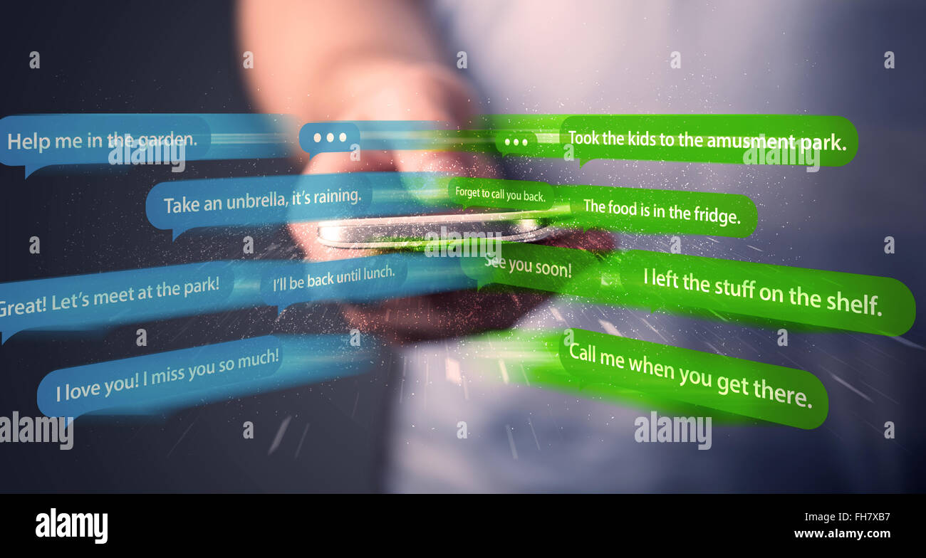 Young man writing messages with smartphone Stock Photo - Alamy