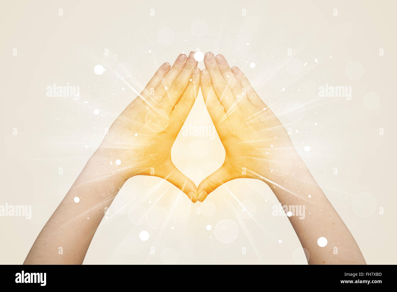 Hands creating a form with yellow shines Stock Photo - Alamy