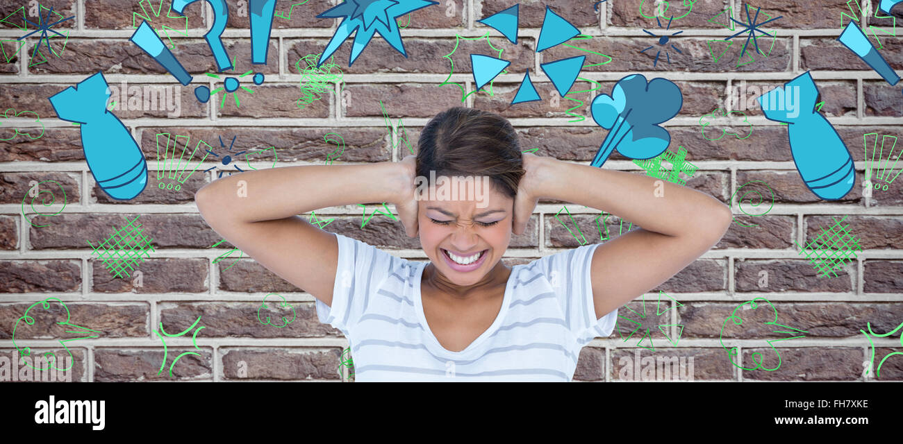 Composite image of angry woman covering ears Stock Photo - Alamy