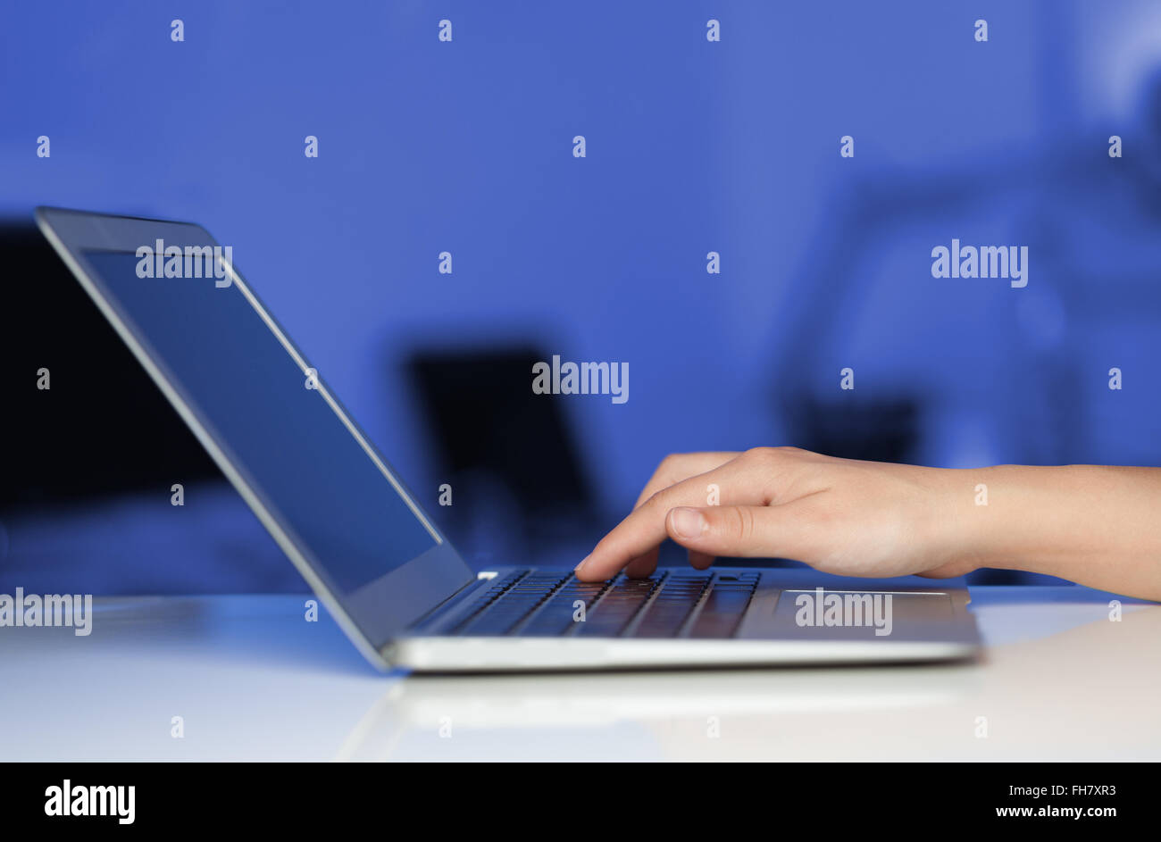 Businessman pressing modern laptop computer on colorful background ...