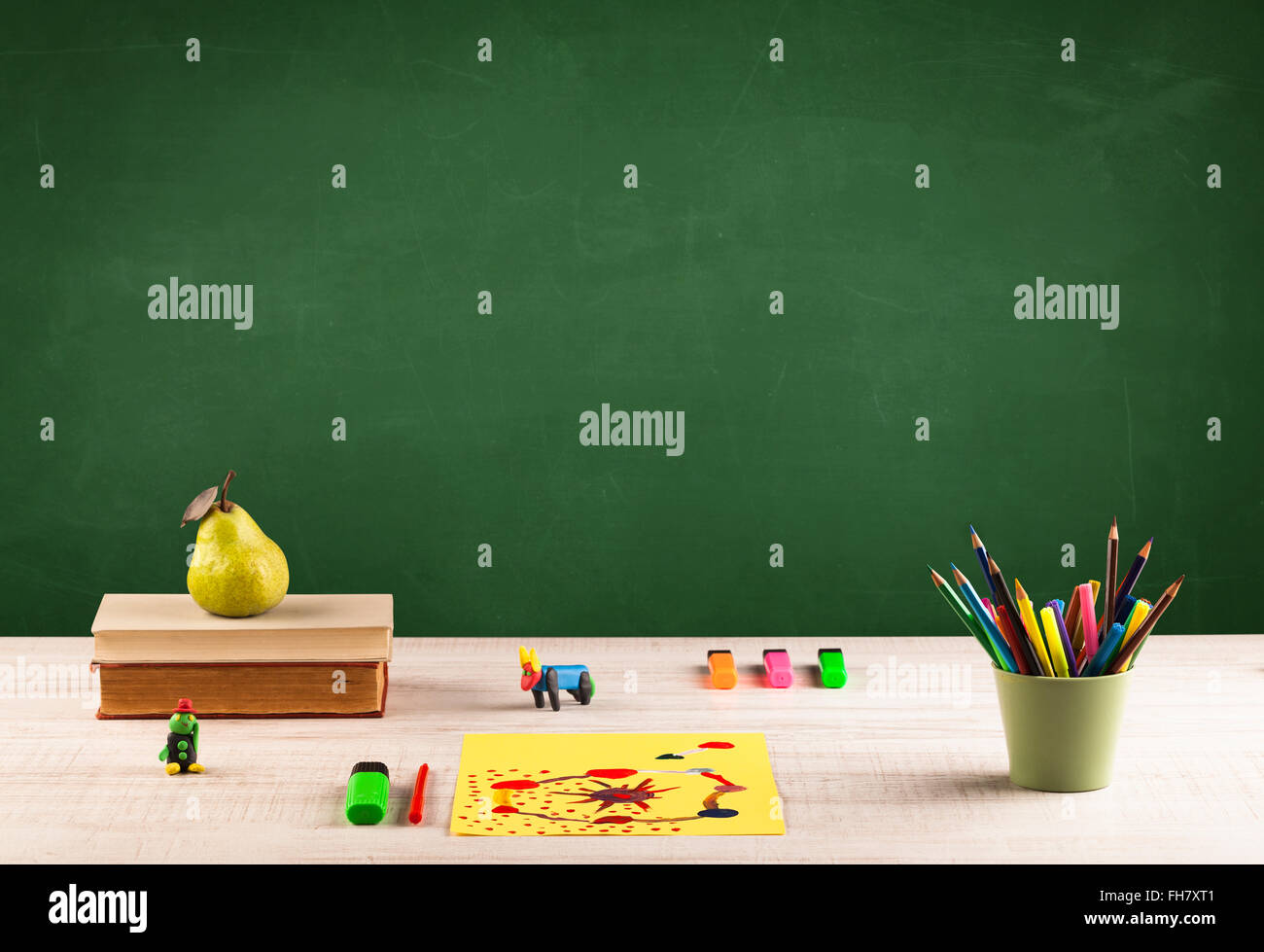 School items on desk with empty chalkboard Stock Photo - Alamy