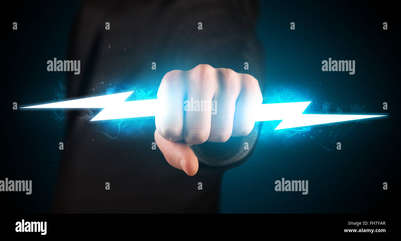 Business man holding glowing lightning bolt in his hands Stock Photo ...