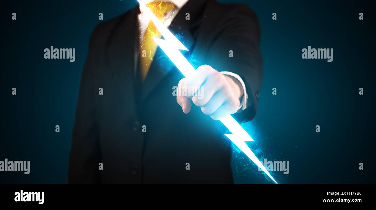 Business man holding glowing lightning bolt in his hands Stock Photo ...