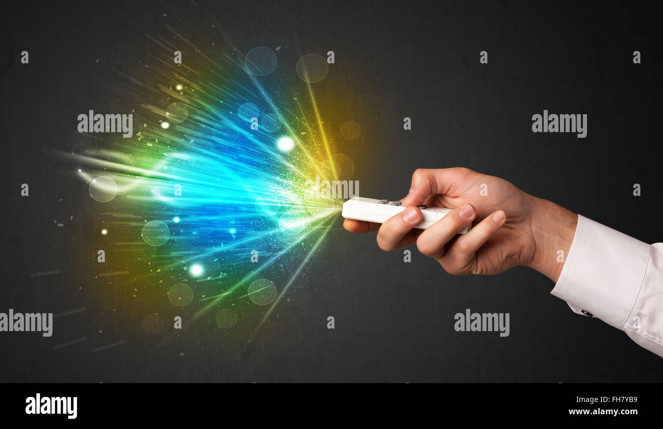 Hand with remote control and explosive signal Stock Photo - Alamy