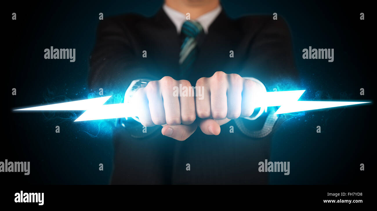 Business man holding glowing lightning bolt in his hands Stock Photo ...