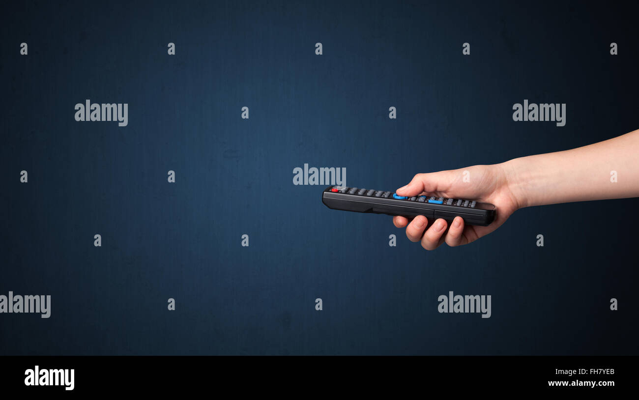 Hand with remote control Stock Photo - Alamy