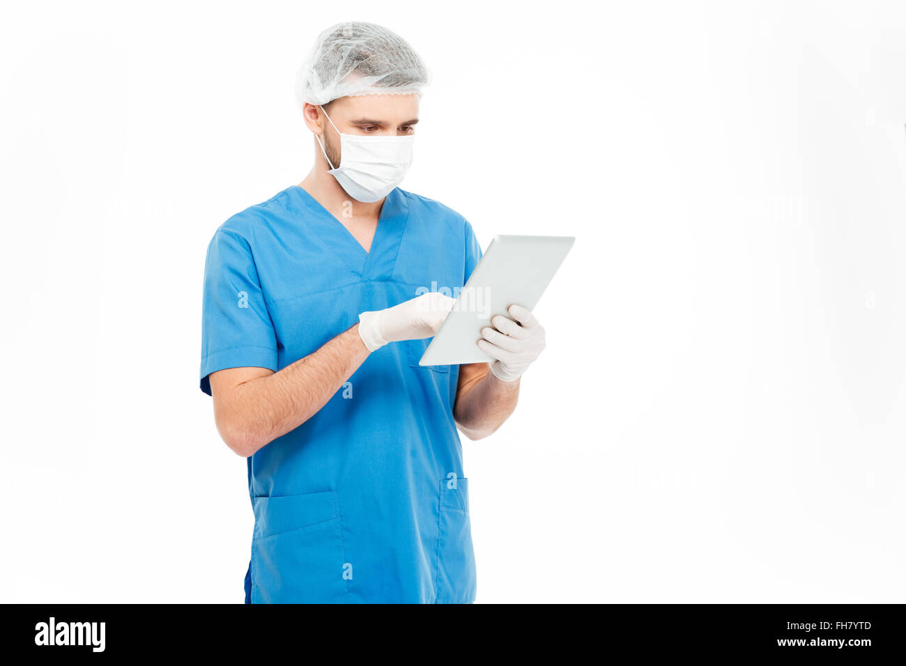 Male surgeon using tablet computer isolated on a white background Stock ...
