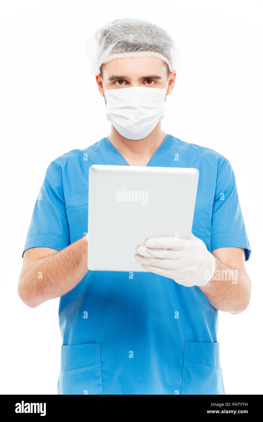 Male surgeon using tablet computer isolated on a white background Stock ...
