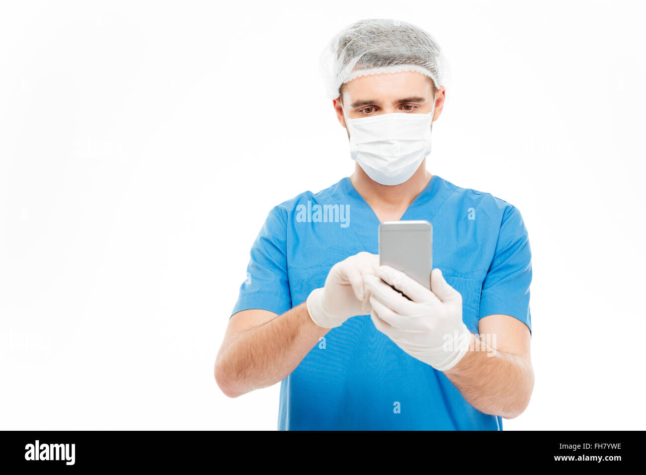 Male surgeon using smartphone isolated on a white background Stock ...