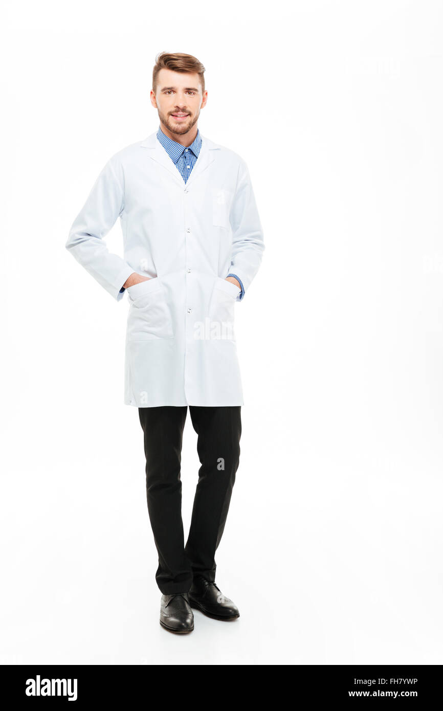 Full length portrait of a young male doctor standing and looking at ...