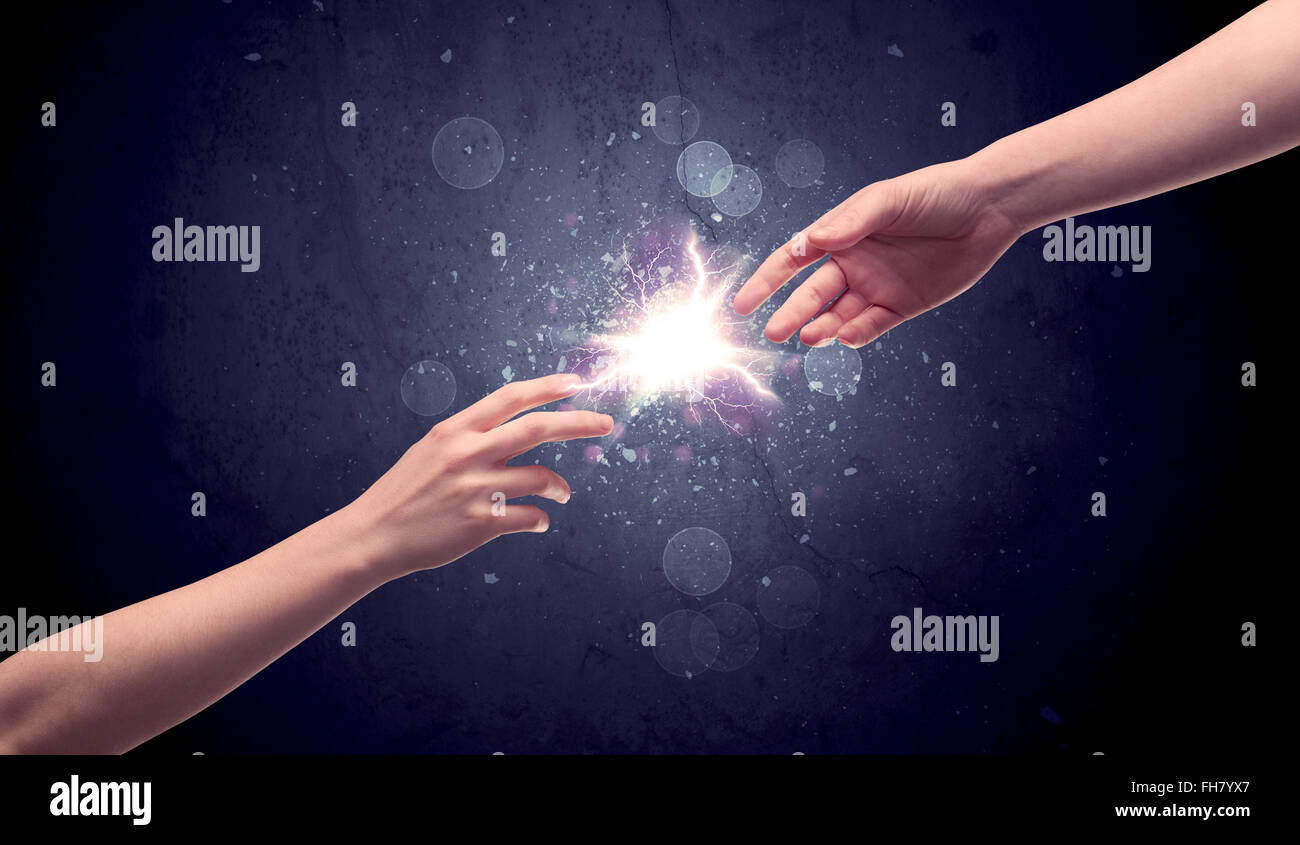 Hands reaching to light a spark Stock Photo - Alamy
