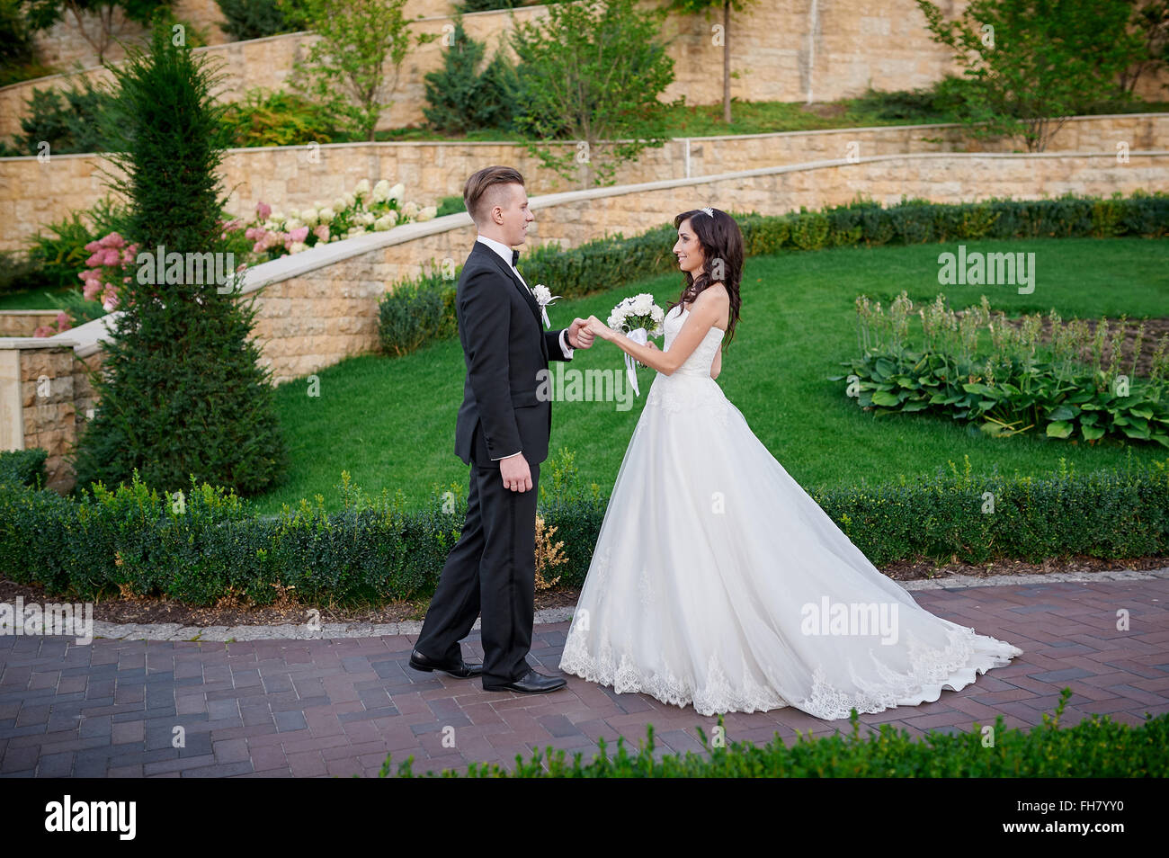 Bride and groom at wedding Day walking Outdoors on spring park Stock ...